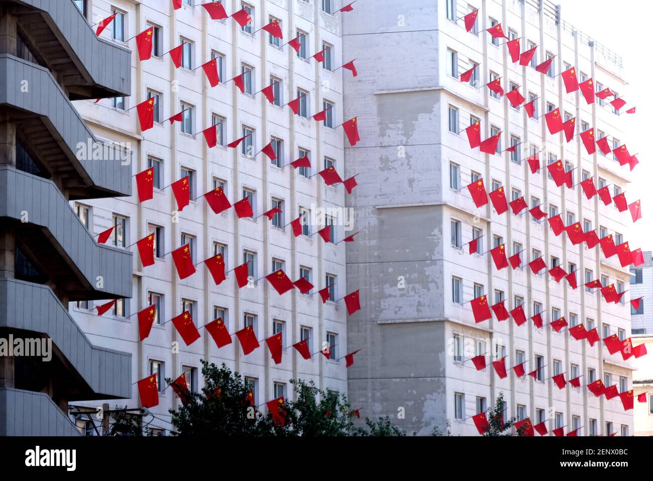 Chinese national flags flutter on the windows at the campus of Liaoning ...
