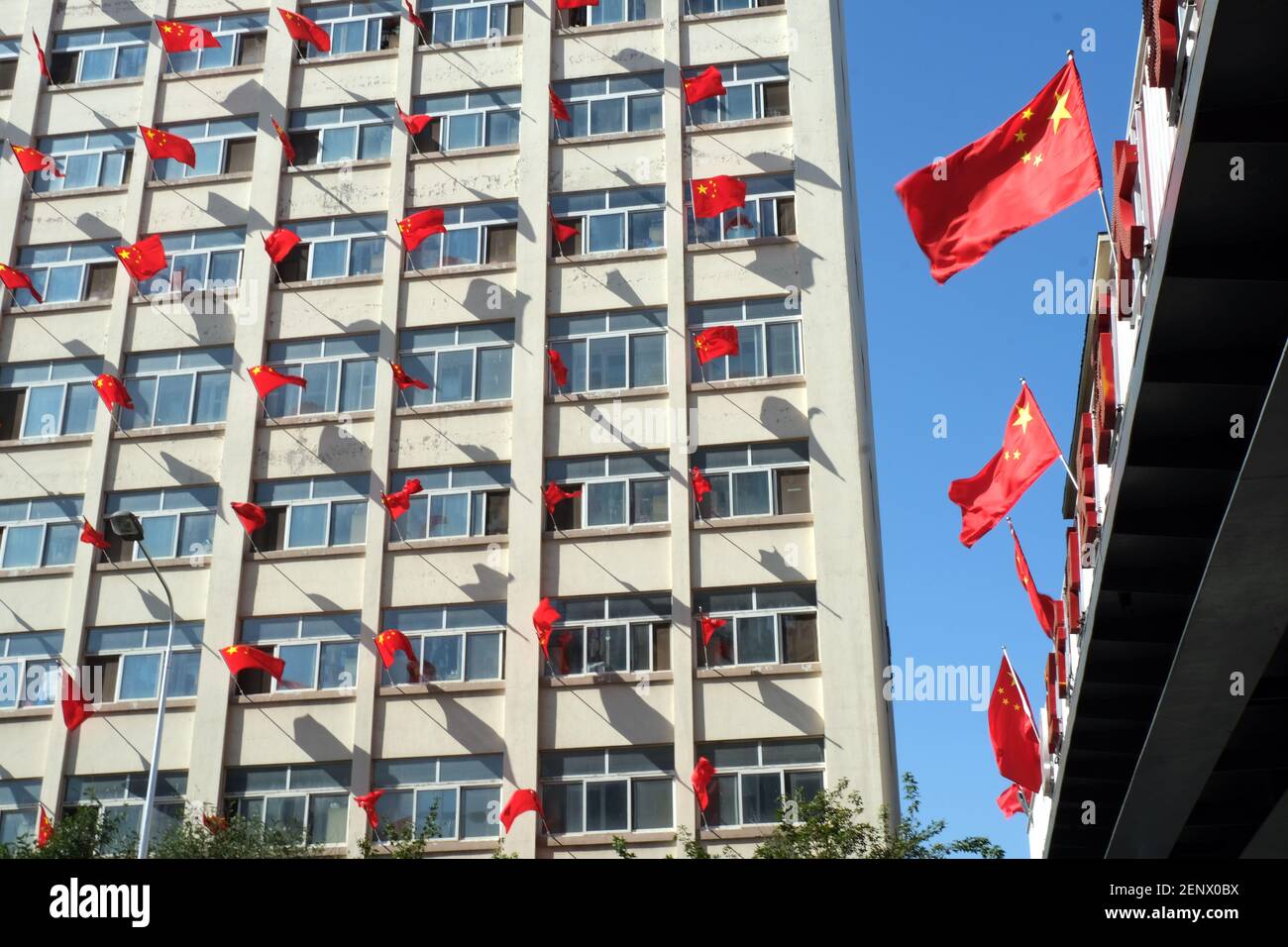 Chinese national flags flutter on the windows at the campus of Liaoning ...