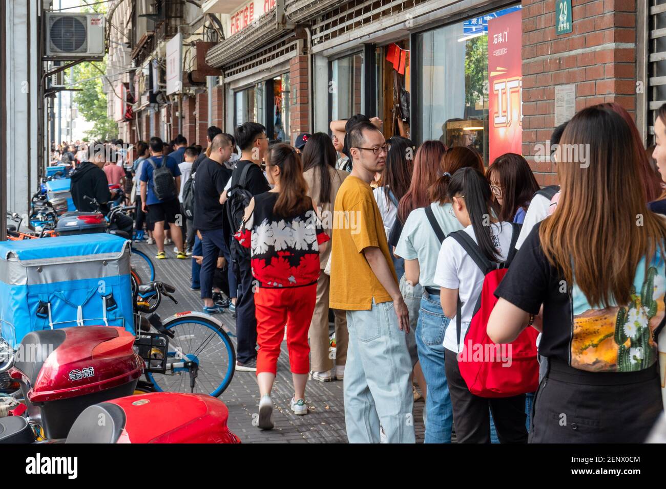 Customers queue up in front of a pop-up store of Machi Machi, which is ...