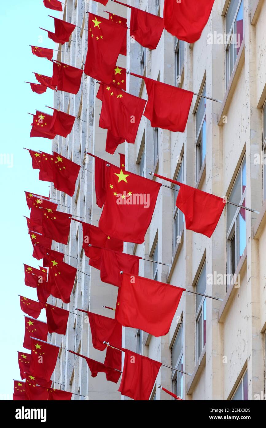 Chinese national flags flutter on the windows at the campus of Liaoning ...