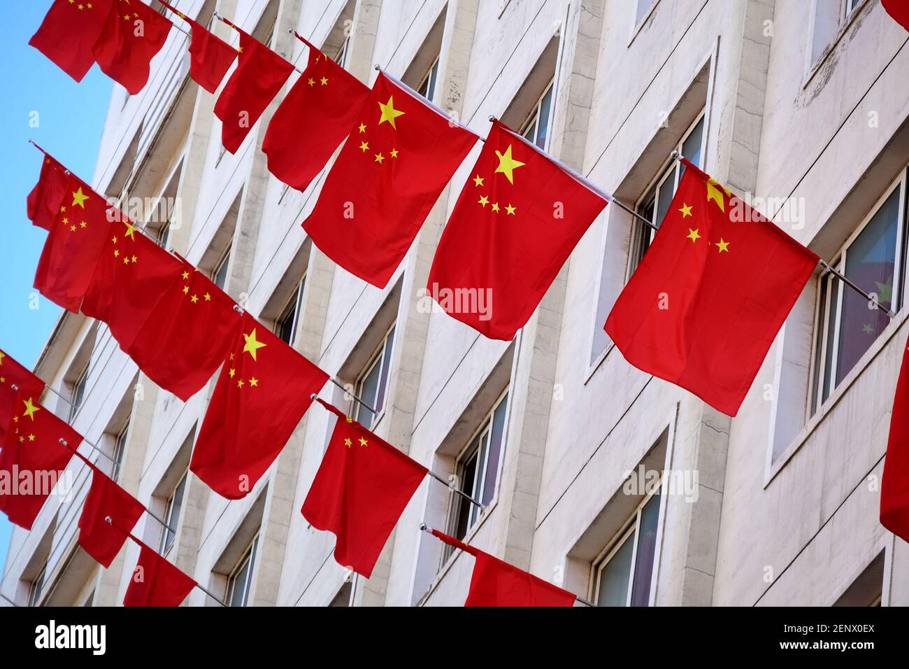 Chinese national flags flutter on the windows at the campus of Liaoning ...