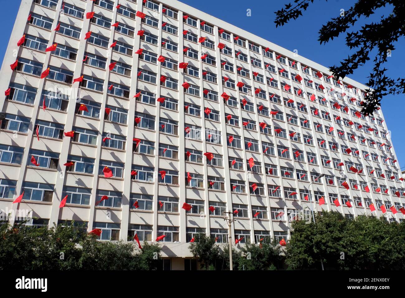 Chinese national flags flutter on the windows at the campus of Liaoning ...