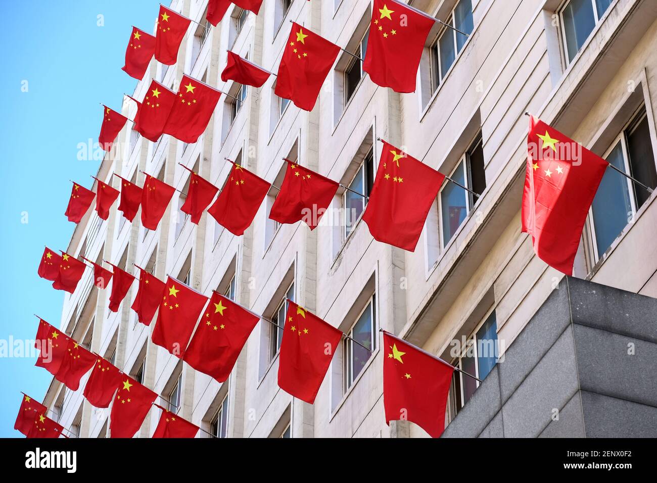 Chinese national flags flutter on the windows at the campus of Liaoning ...