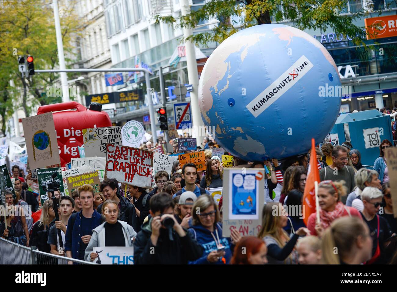 Protesters hold placards during the march. In more than 150 countries ...