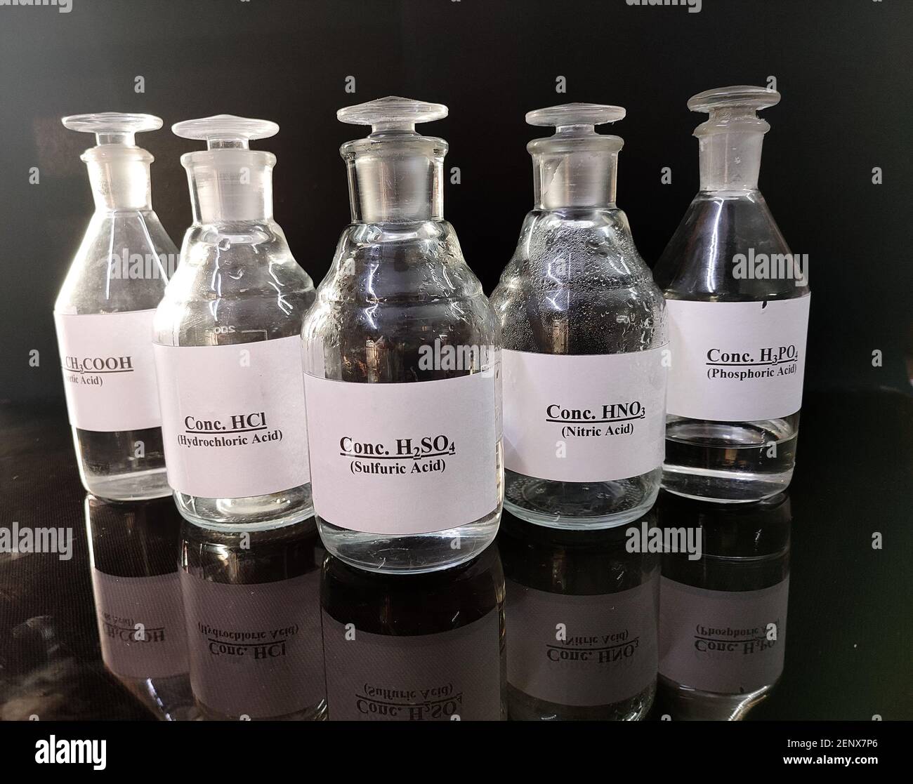 transparent bottles filled with concentrated acid Stock Photo - Alamy
