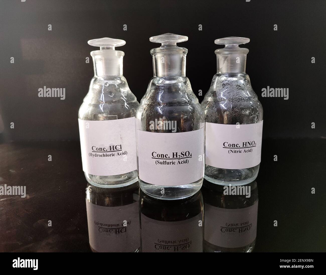 transparent bottles filled with concentrated acid Stock Photo - Alamy