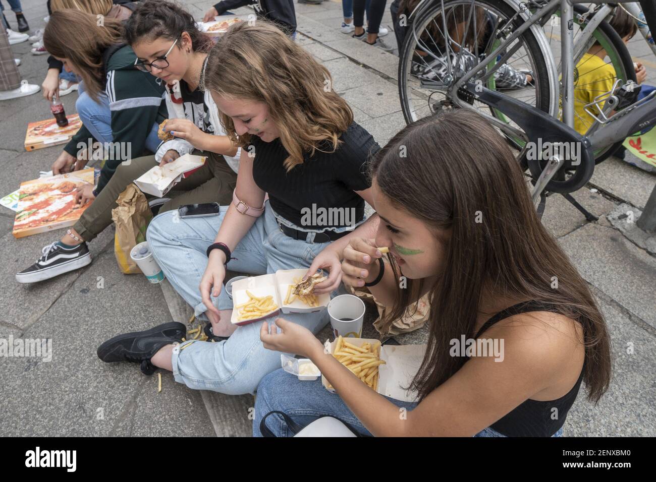 Students seen eating McDonald’s food while seated on the ground during ...