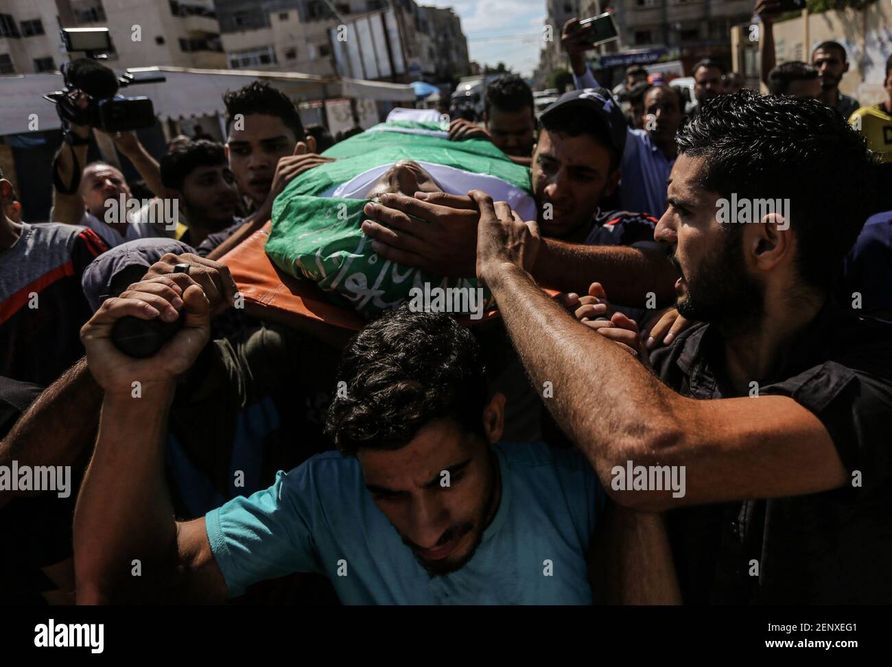 (EDITOR’S NOTE: Image depicts death.) Mourners carry the body of the ...