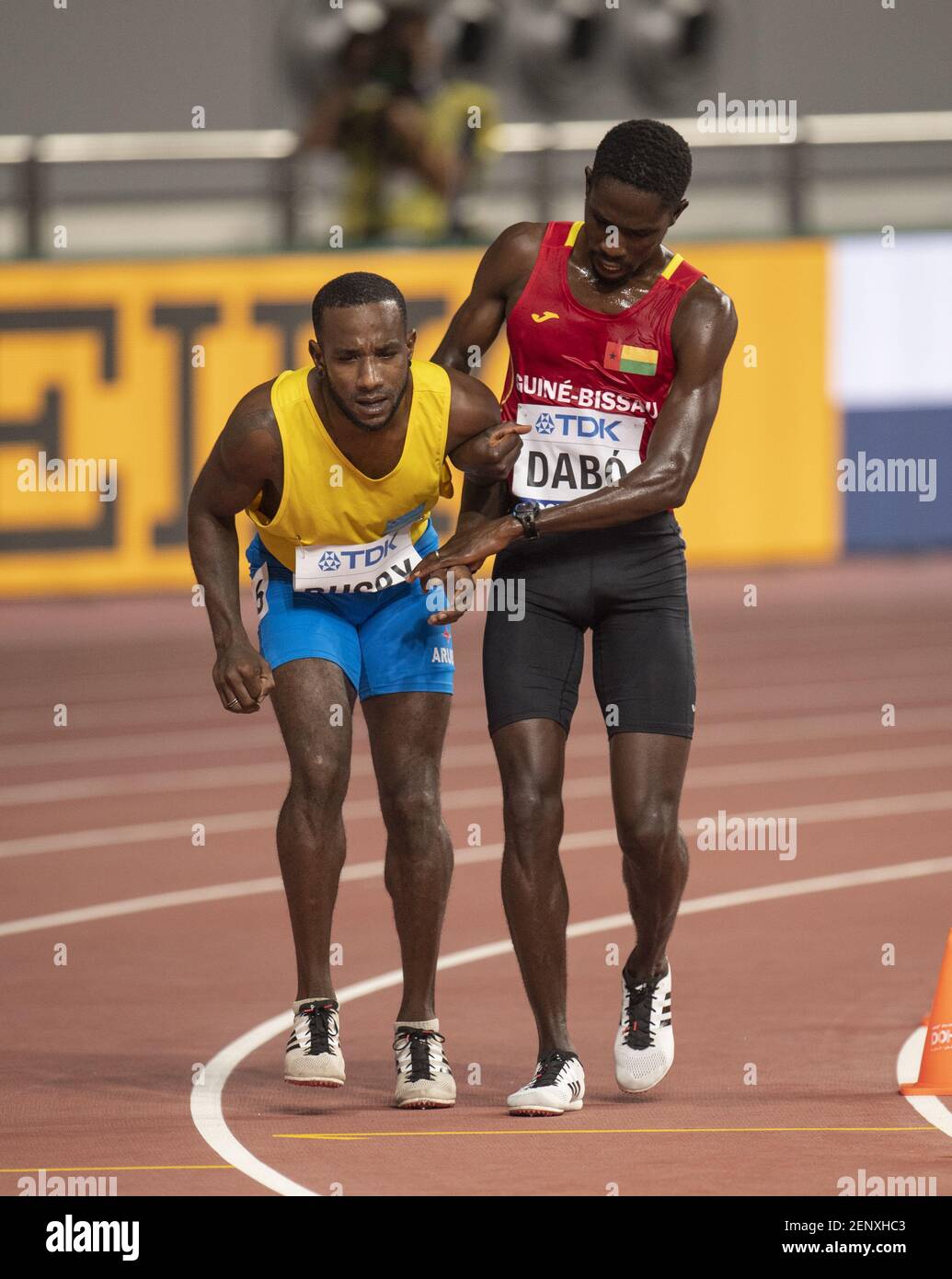 Braima Suncar Dabo of Guinea-Bissau helps Jonathan Busby of Aruba in ...