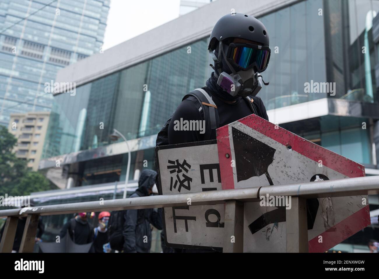 A protester uses a road sign as a shield during the clashes with police ...