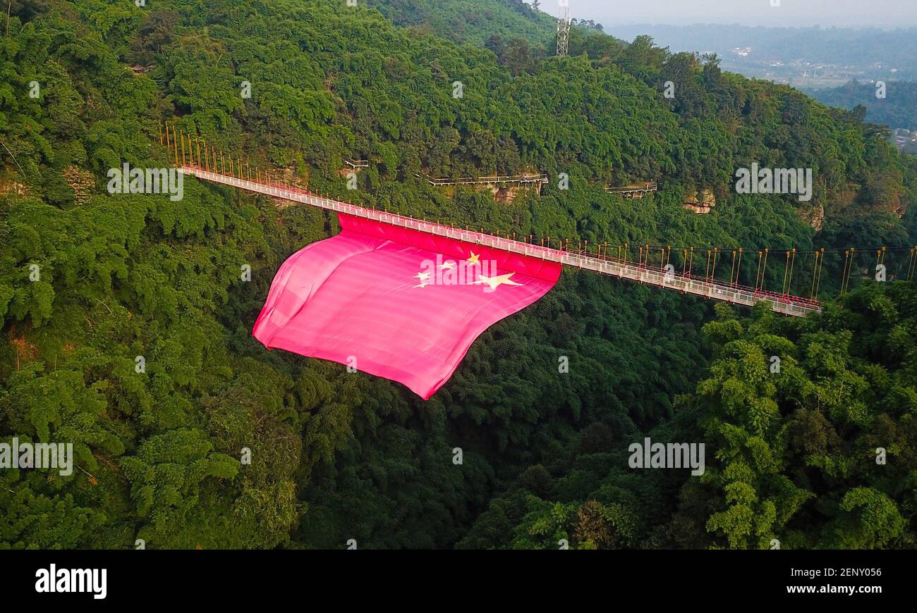 A 70-meter long National flag is equipped at a bridge above a canyon to ...