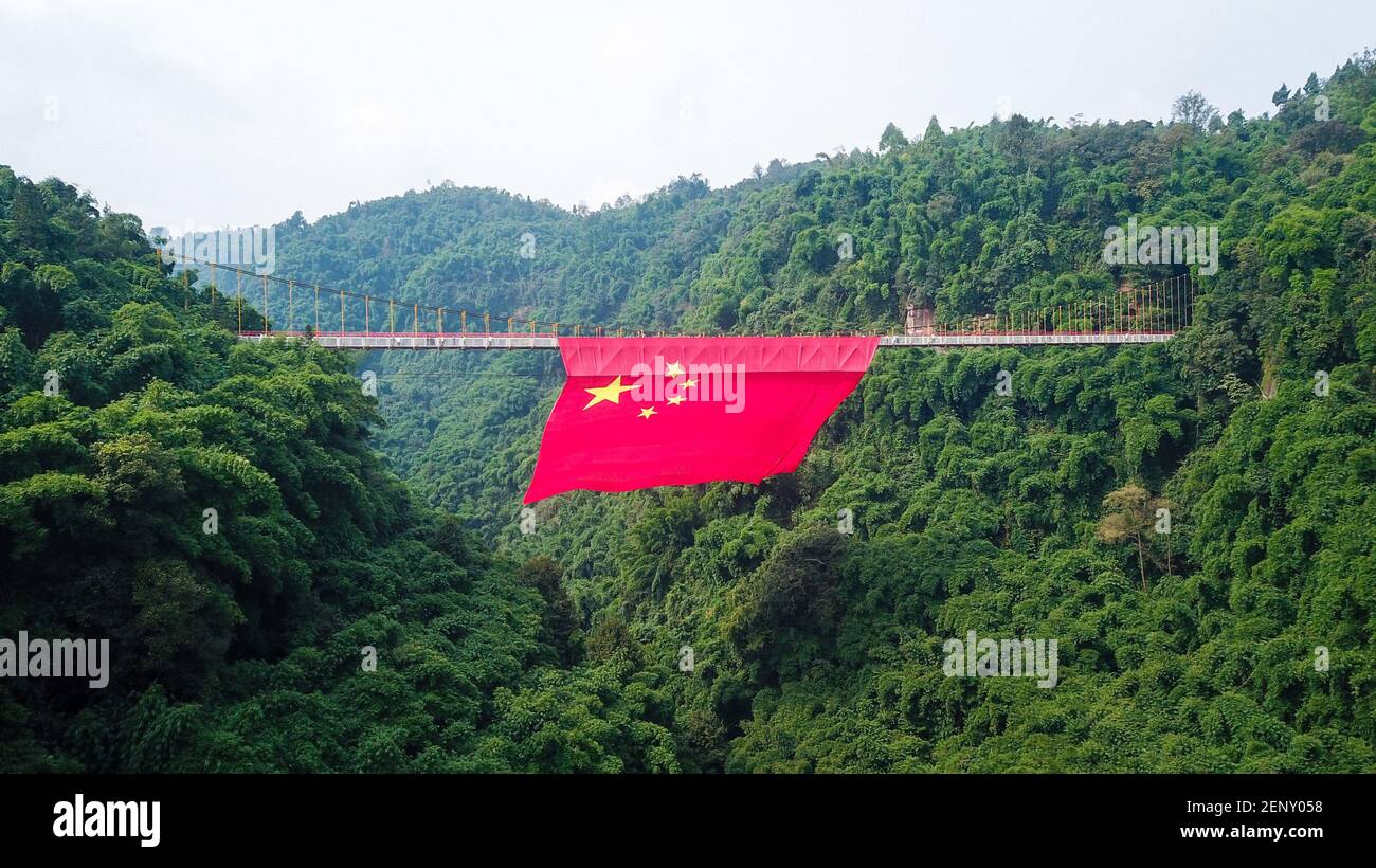A 70-meter long National flag is equipped at a bridge above a canyon to ...
