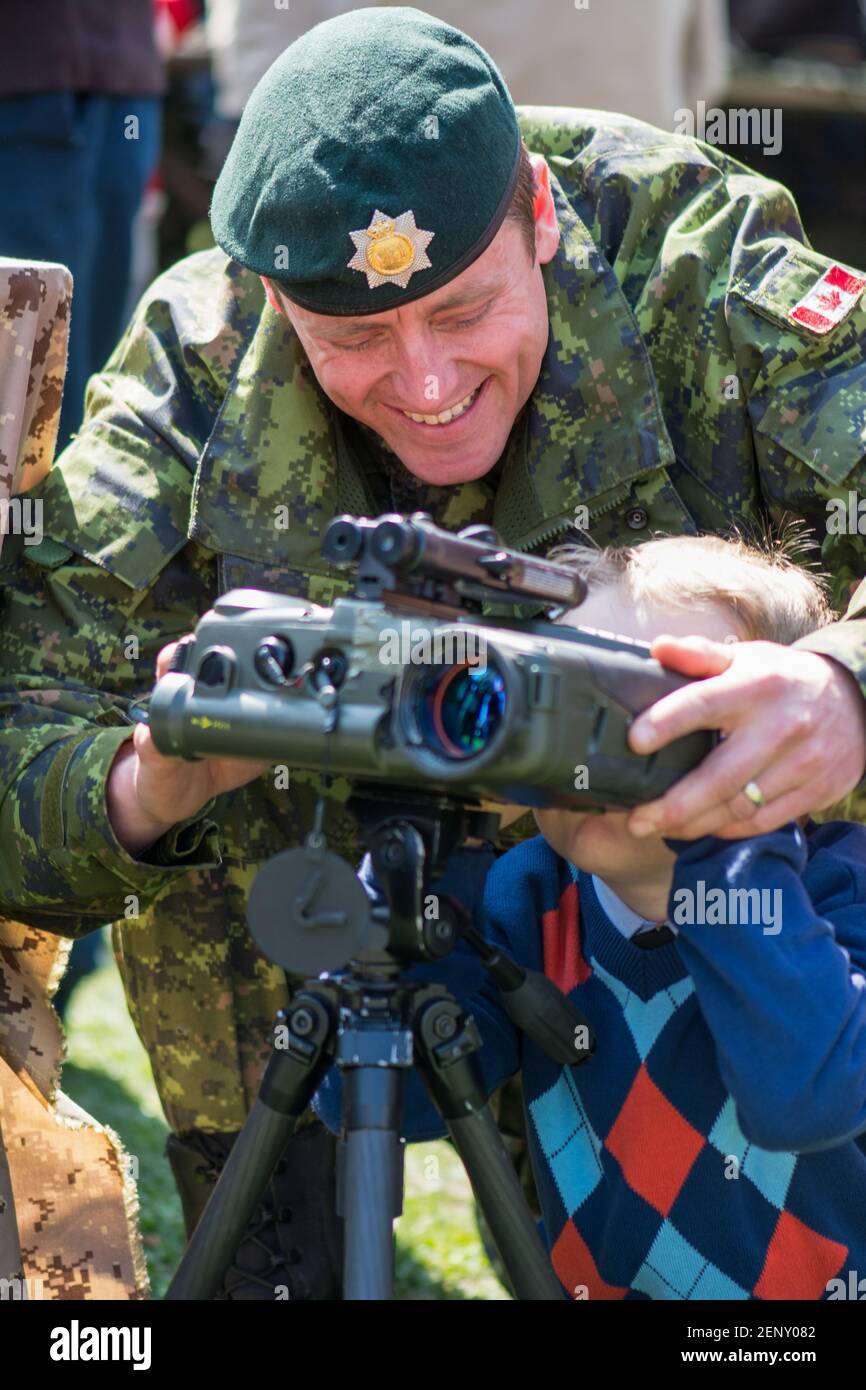 Canadian Army display, Smiling soldiers helps boy looks to the military ...
