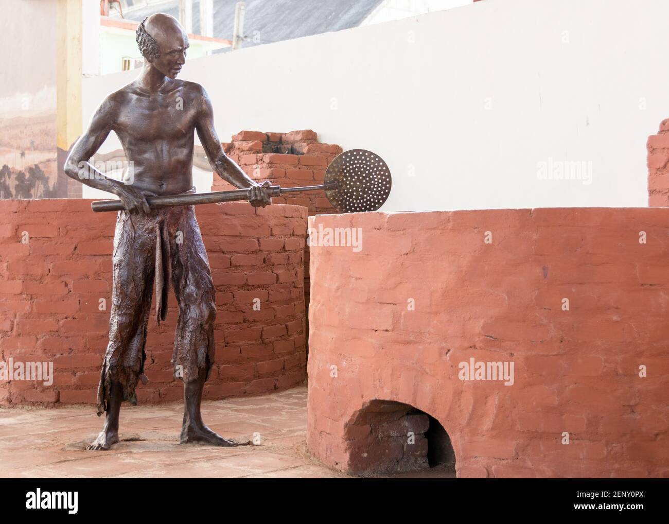 Statue of African slave working in a vintage Cuban sugar mill conserved ...
