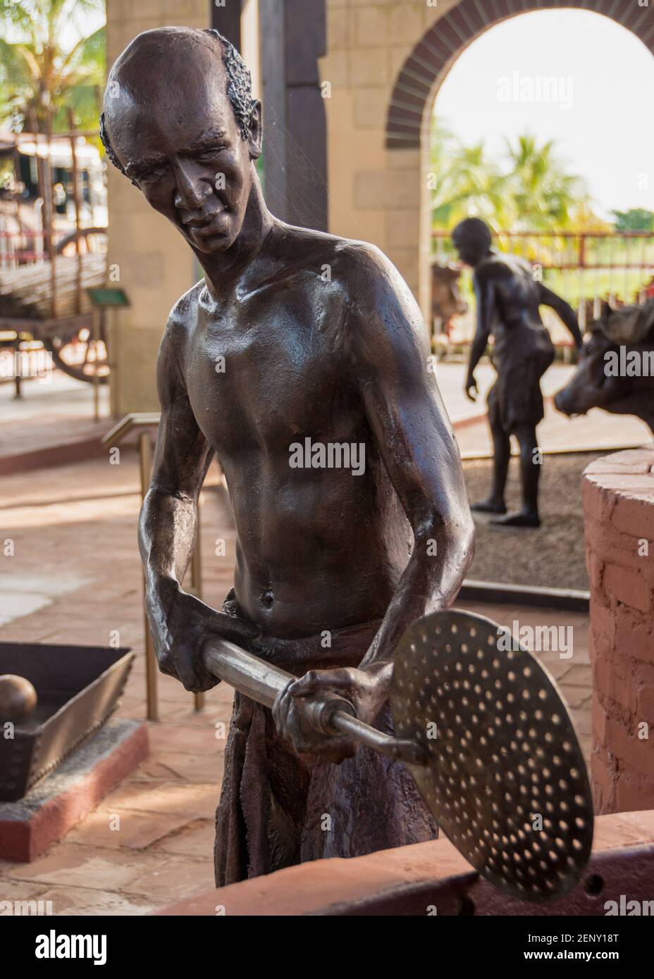 Statue of African slave working in a vintage Cuban sugar mill conserved ...