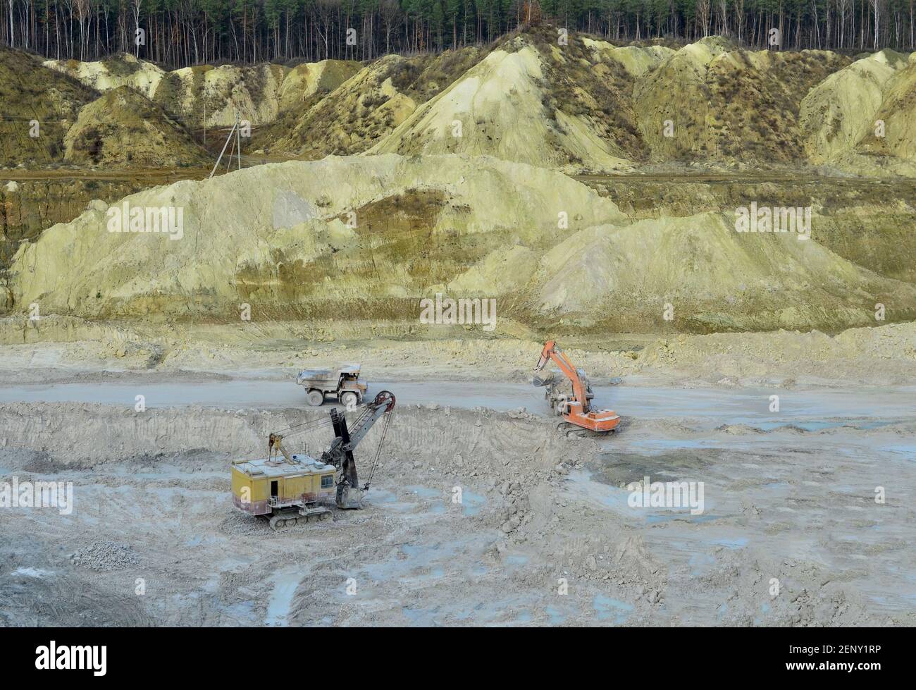 Excavator in quarry loads rock into a mining truck. Excavators and ...