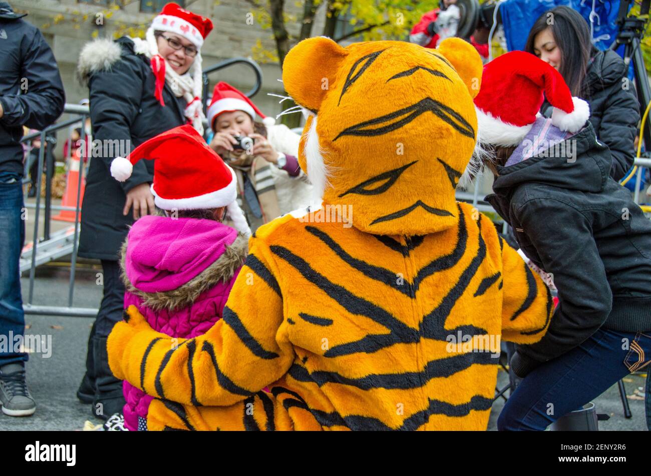 Tiger costume entertainer giving photos to the general public in ...