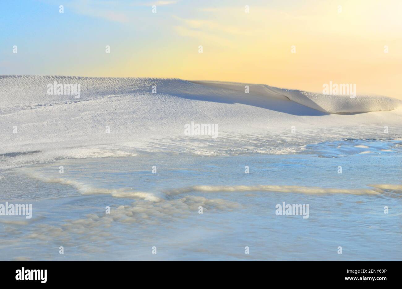 Structure of snow and ice on frozen lake on sunset background. Winter ...