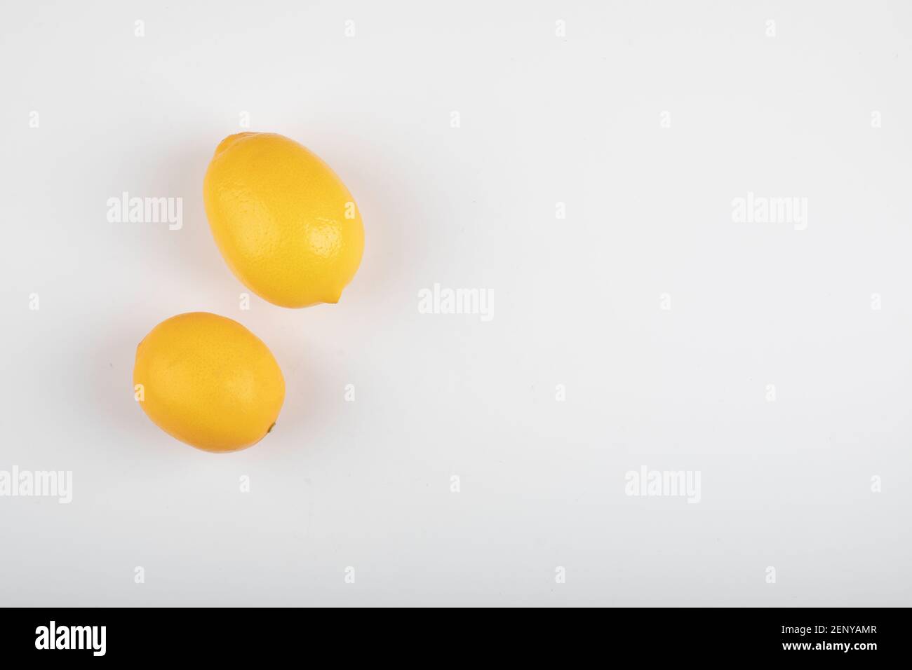 Two yellow lemons isolated on white background Stock Photo - Alamy