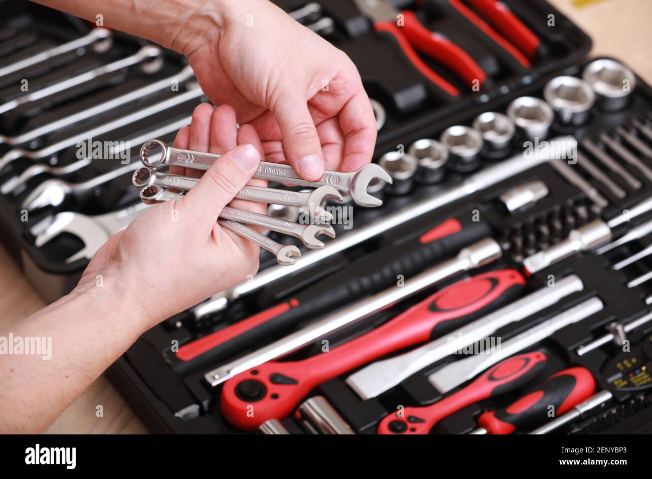 Tool store. Closeup of male hand holding wrenches. Auto repair kit in ...
