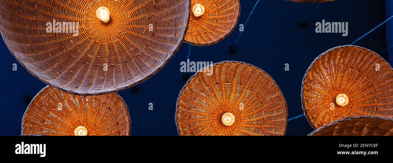 lamps in straw shades on the ceiling for decoration Stock Photo - Alamy