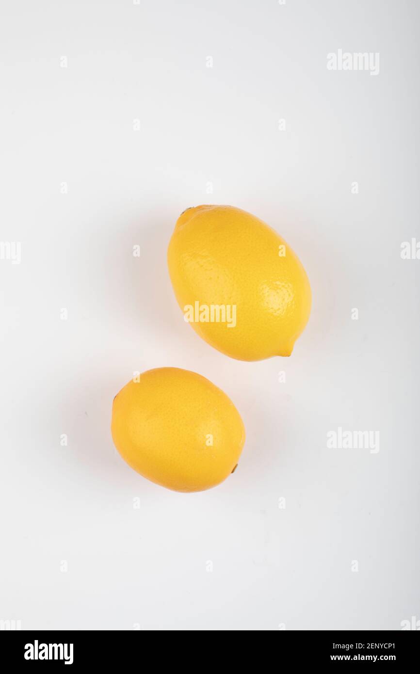 Two yellow lemons isolated on white background Stock Photo - Alamy