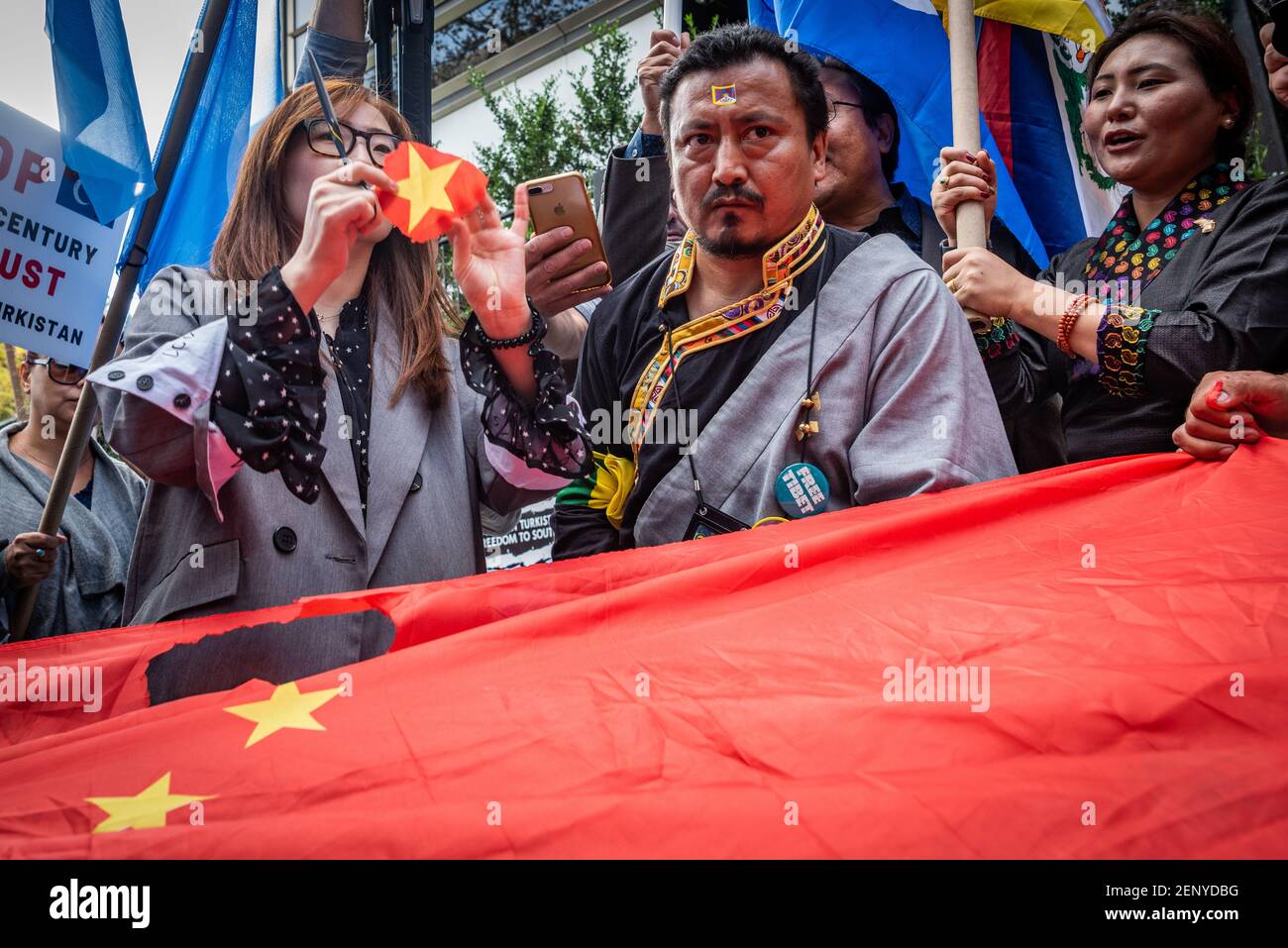 Symbolizing an end to Chinese oppression, protestors cut out the stars ...