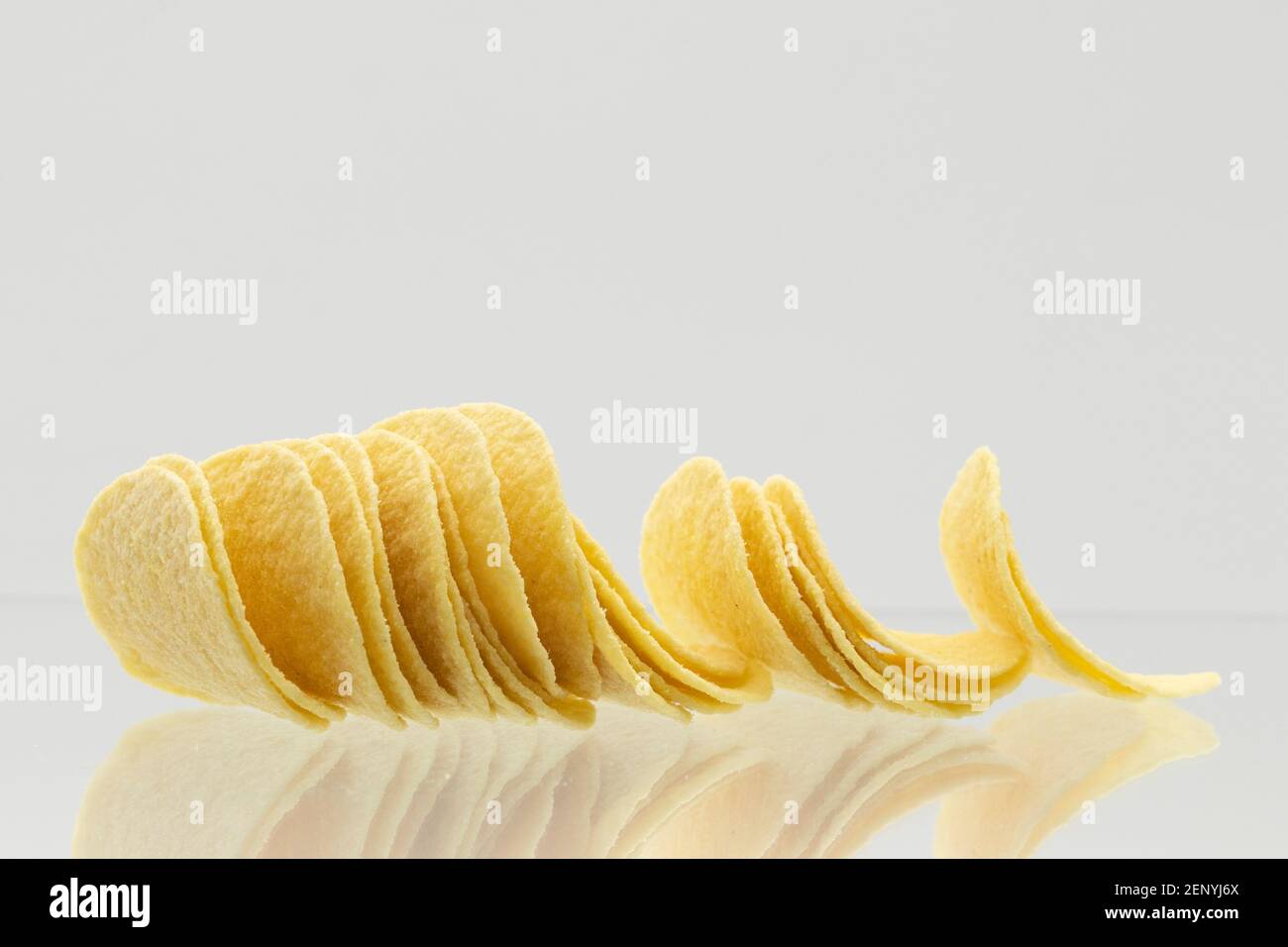 Crispy delicious potato crisps chips snack on a gray background with ...