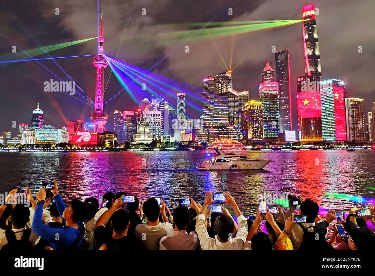 Tourists gather at the Bund to enjoy the light show performed with ...