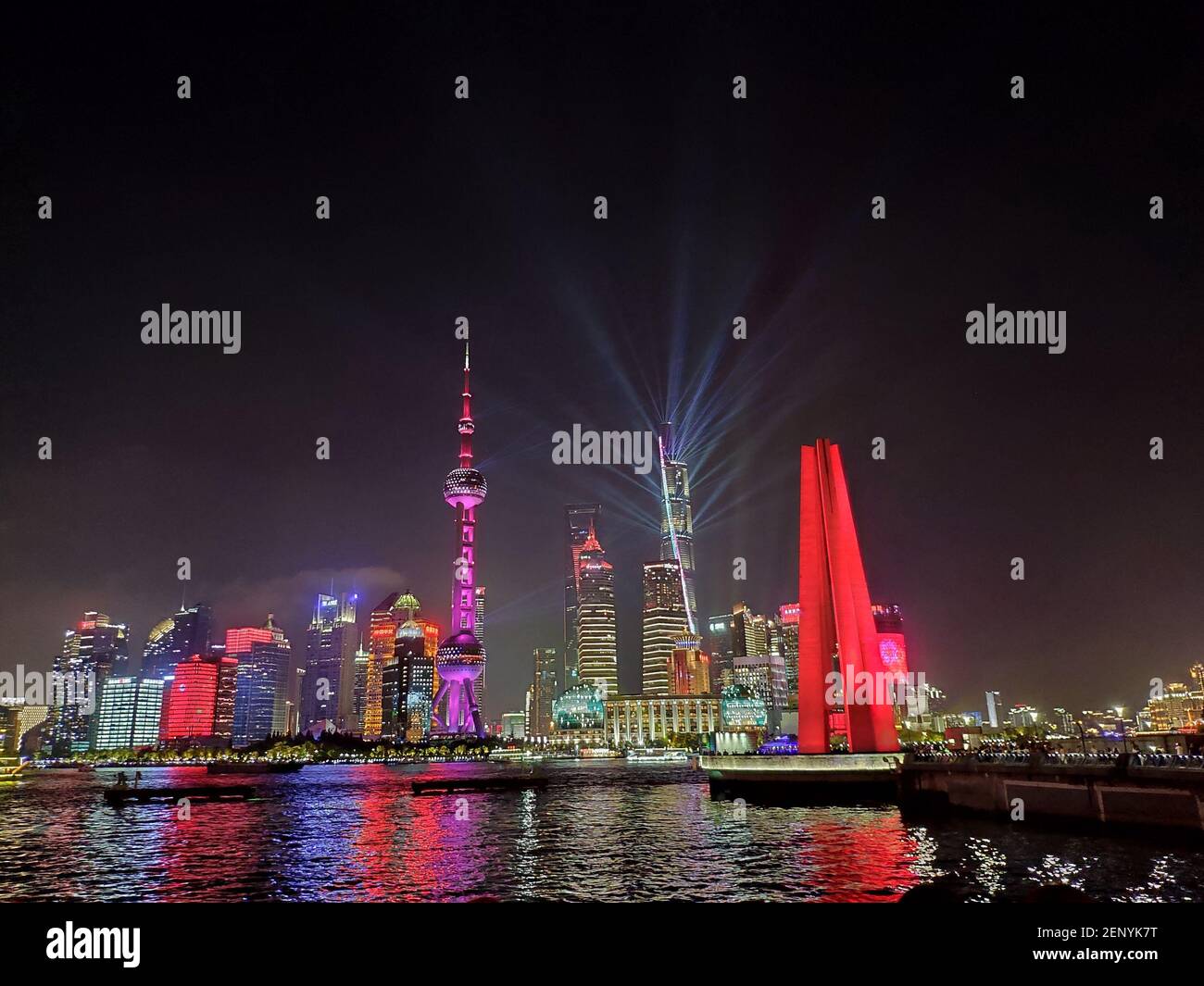 Tourists gather at the Bund to enjoy the light show performed with ...