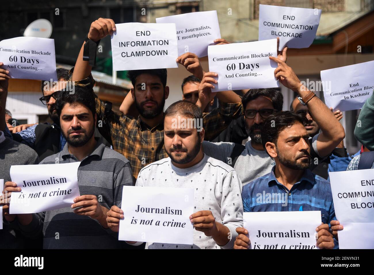 Journalists hold placards during the protest. Journalists hold a ...