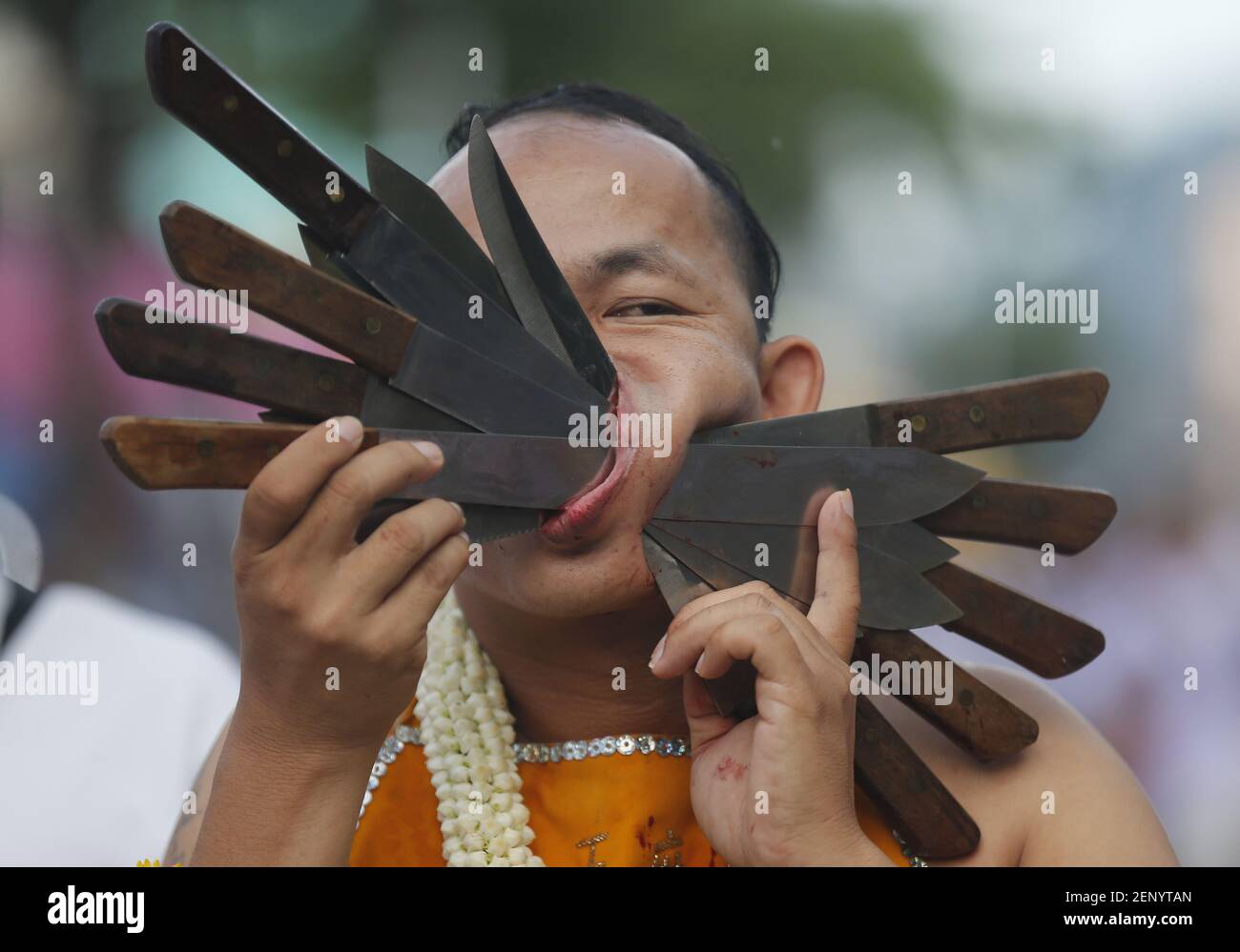 A devotee of the Chinese Bang Neow shrine with his face pierced with ...