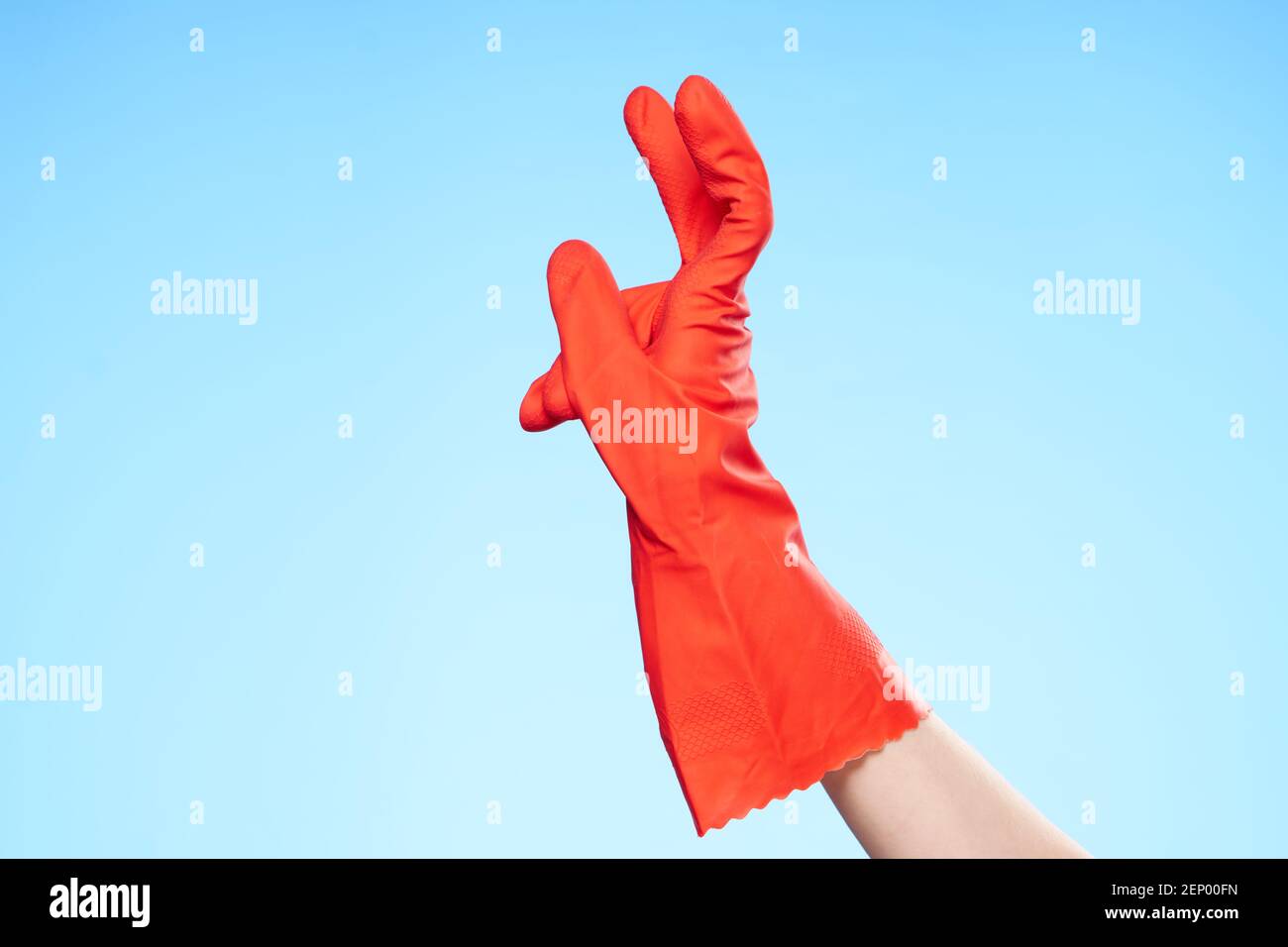 hand in red rubber gloves gesturing blue background cleaning Stock ...