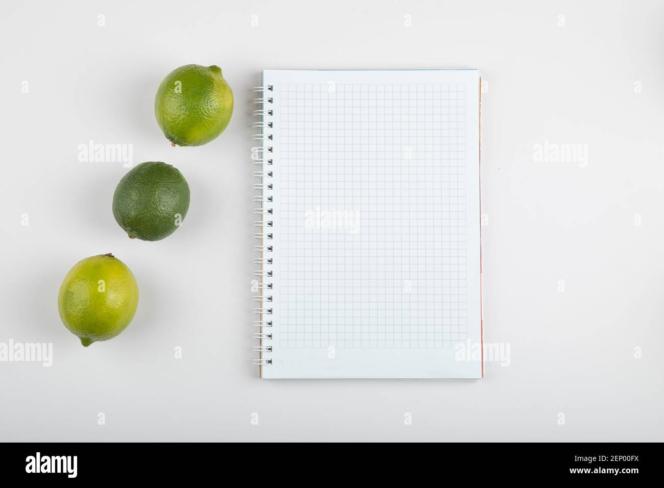 Fresh ripe lime fruits and empty page on white background Stock Photo ...
