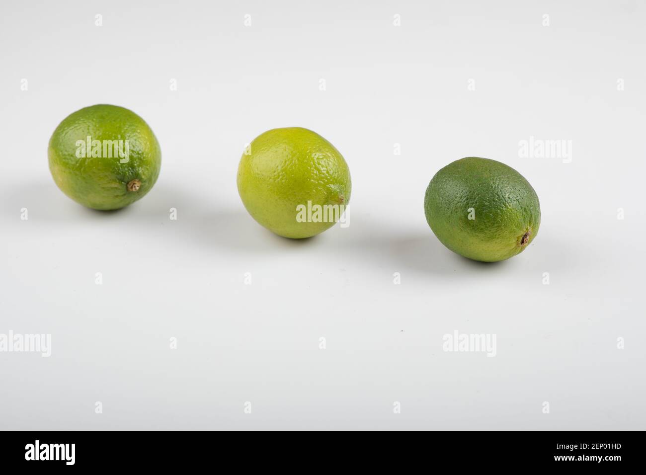 Three ripe lime fruits isolated on white background Stock Photo - Alamy