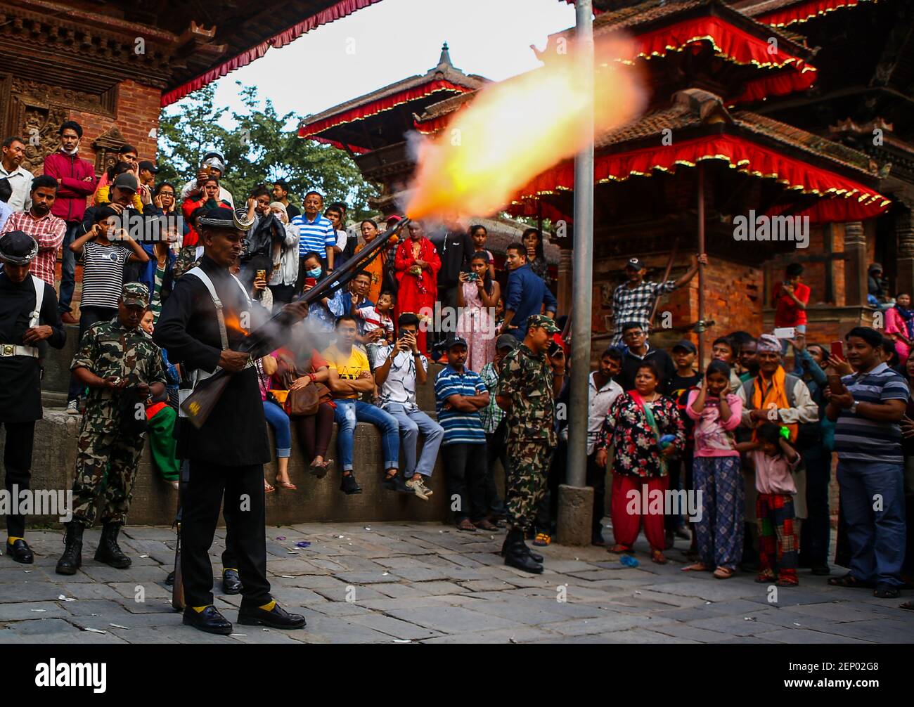 Nepali soldiers dressed in traditional outfits fire muskets during the ...