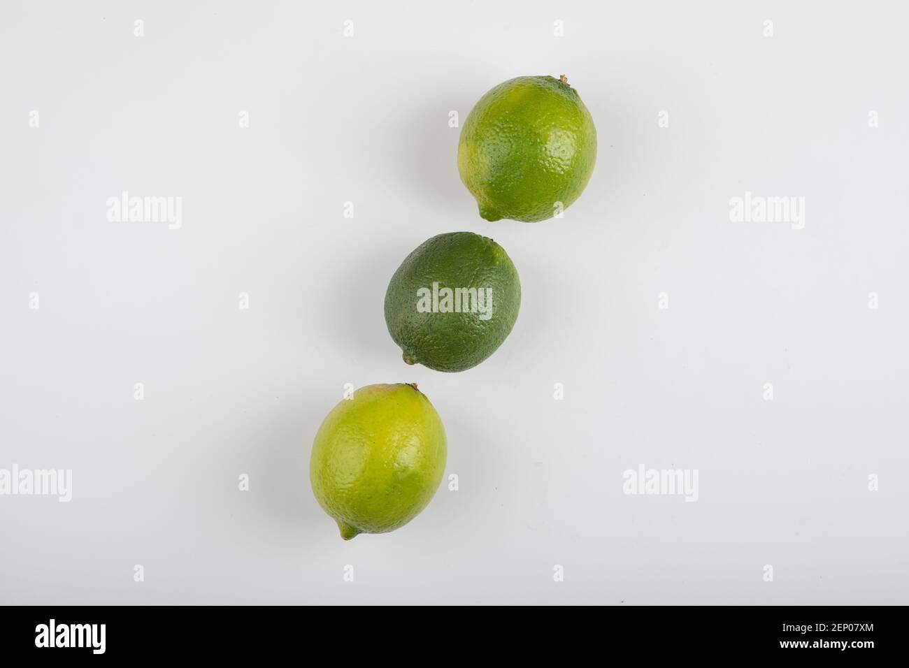 Three ripe lime fruits isolated on white background Stock Photo - Alamy