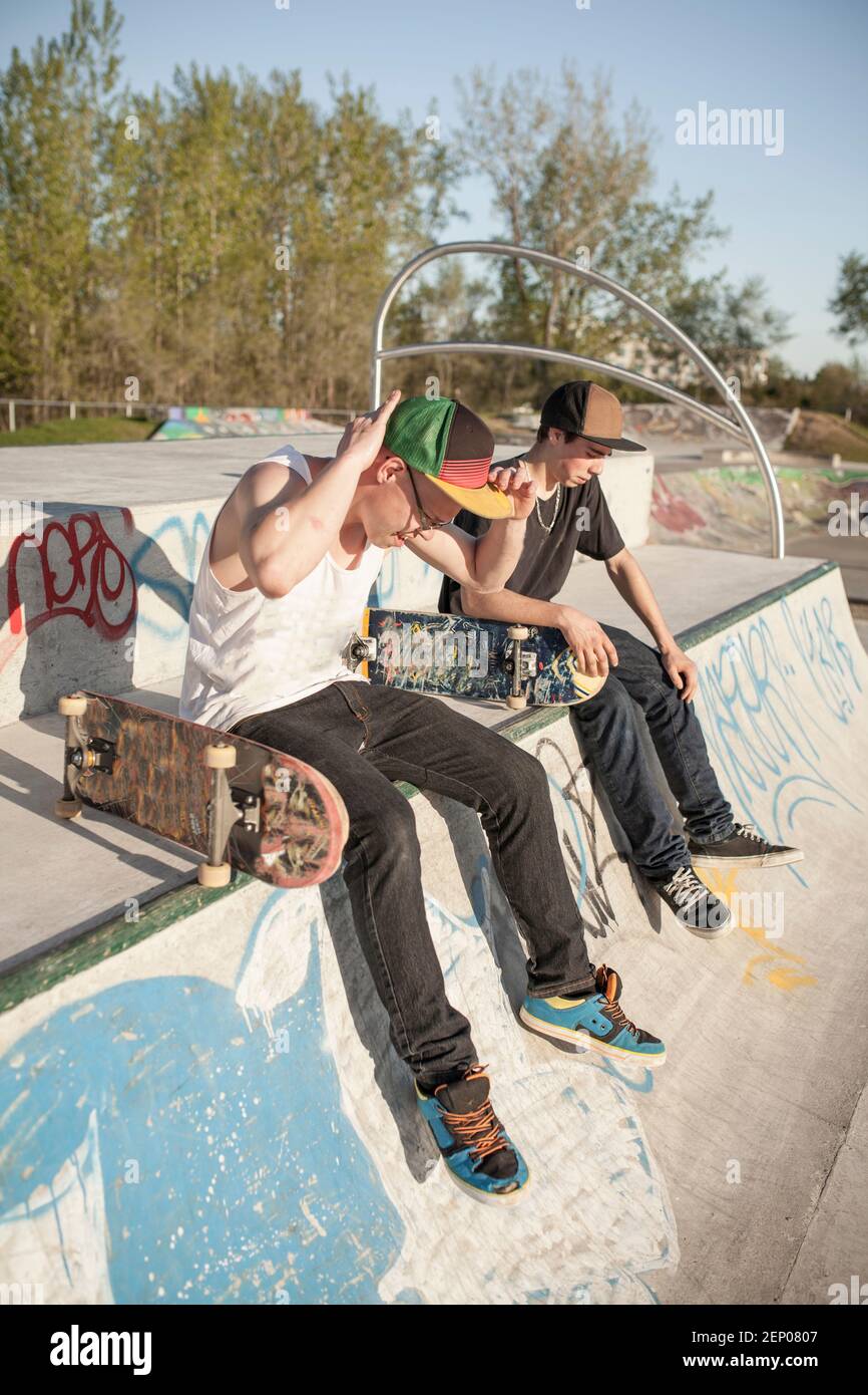 Skateboarder outside skateboarding on sunny day hanging out together ...