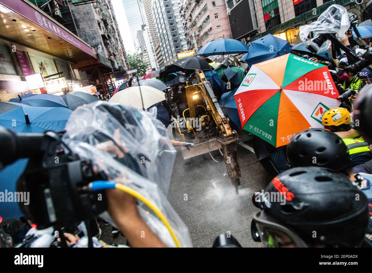 A protester grabs hold of an excavator during the demonstration ...