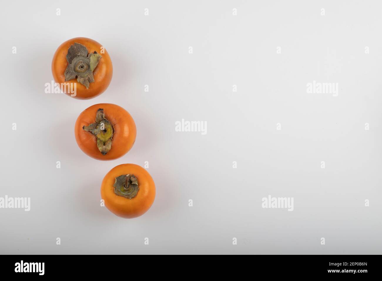 Three fresh persimmon kaki fruits isolated on white background Stock ...