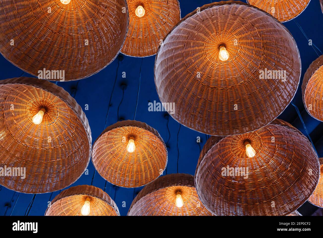 lamps in straw shades on the ceiling for decoration Stock Photo - Alamy