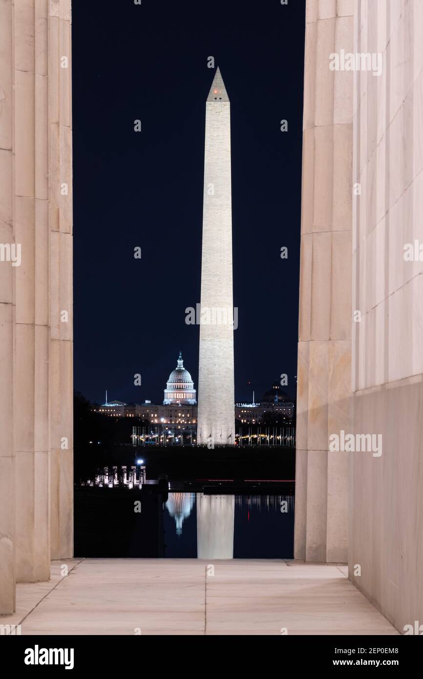The National Mall at night shot through the Lincoln Memorial columns ...