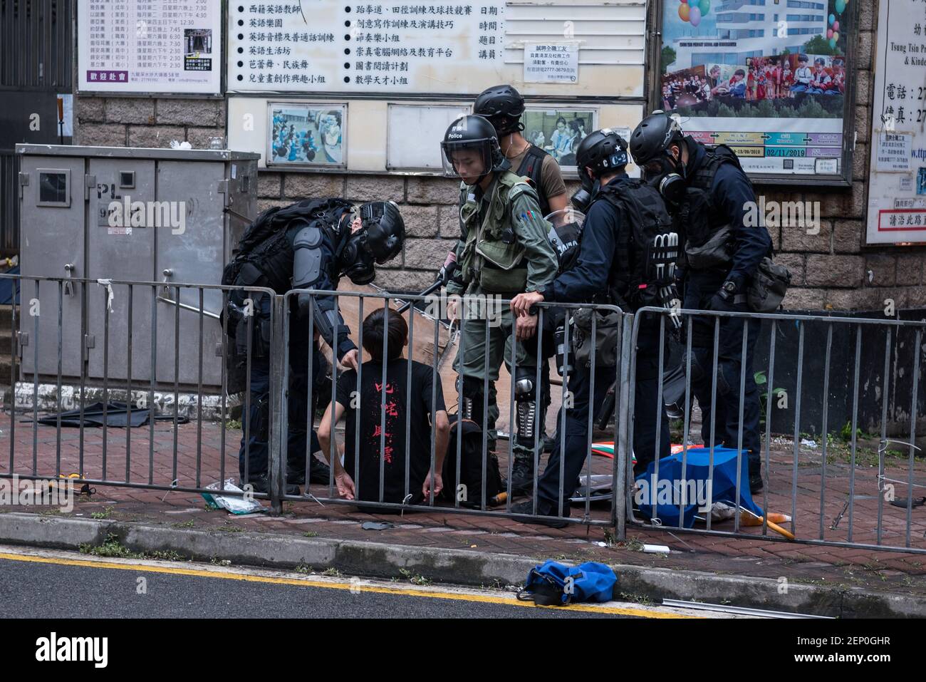 Riot police question a protester after capturing him during a dispersal ...
