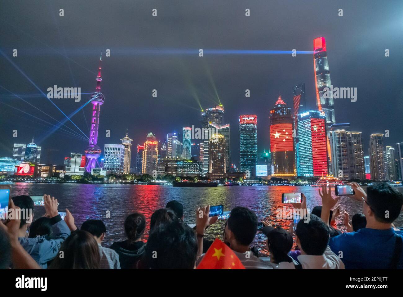 Tourists gather at the Bund to enjoy the light show performed with ...