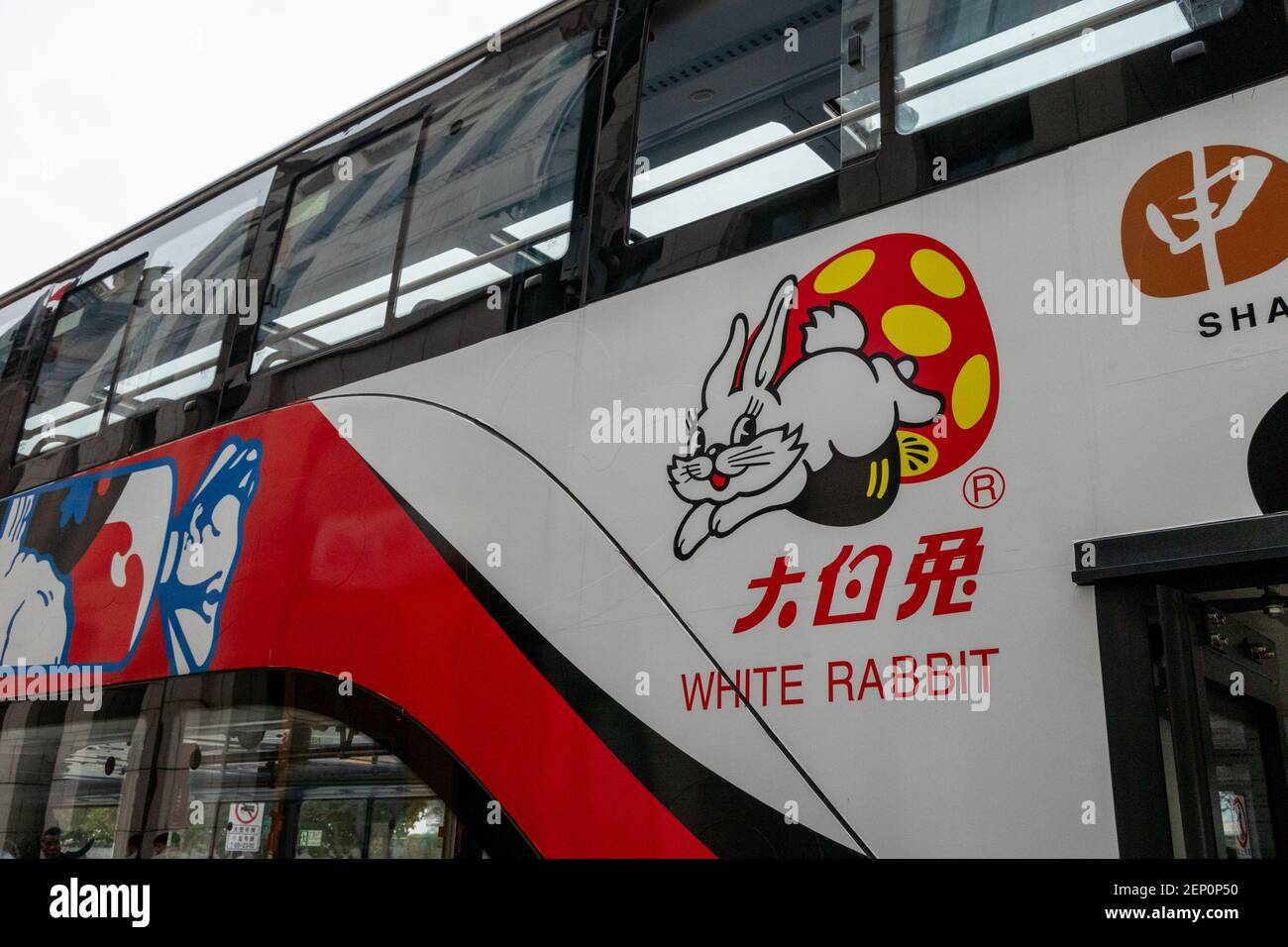 A sightseeing bus with the elements of White Rabbit Canday, a brand of ...