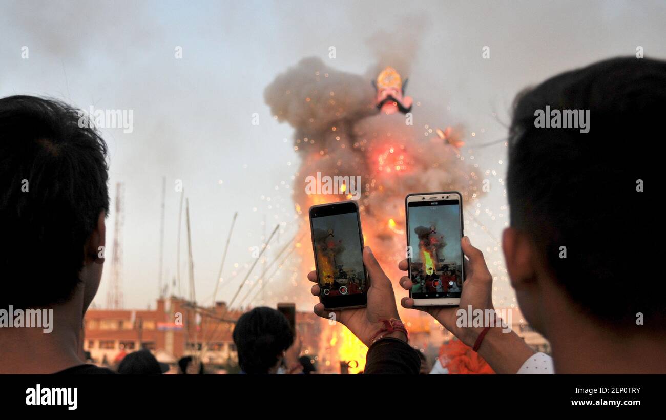 JAMMU, INDIA - OCTOBER 8: People take pictures ads an an effigy of ...