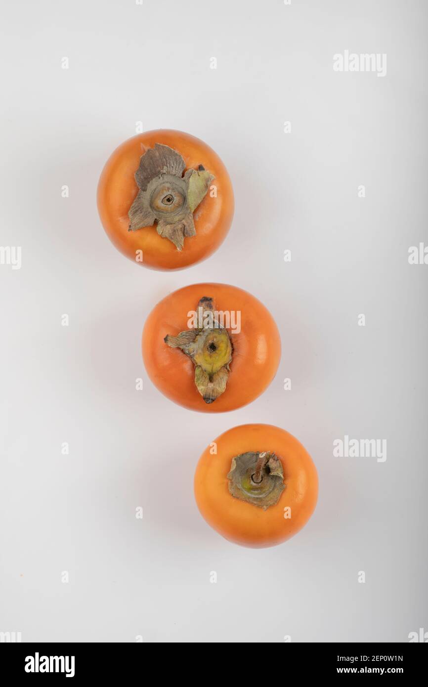 Three fresh persimmon kaki fruits isolated on white background Stock ...