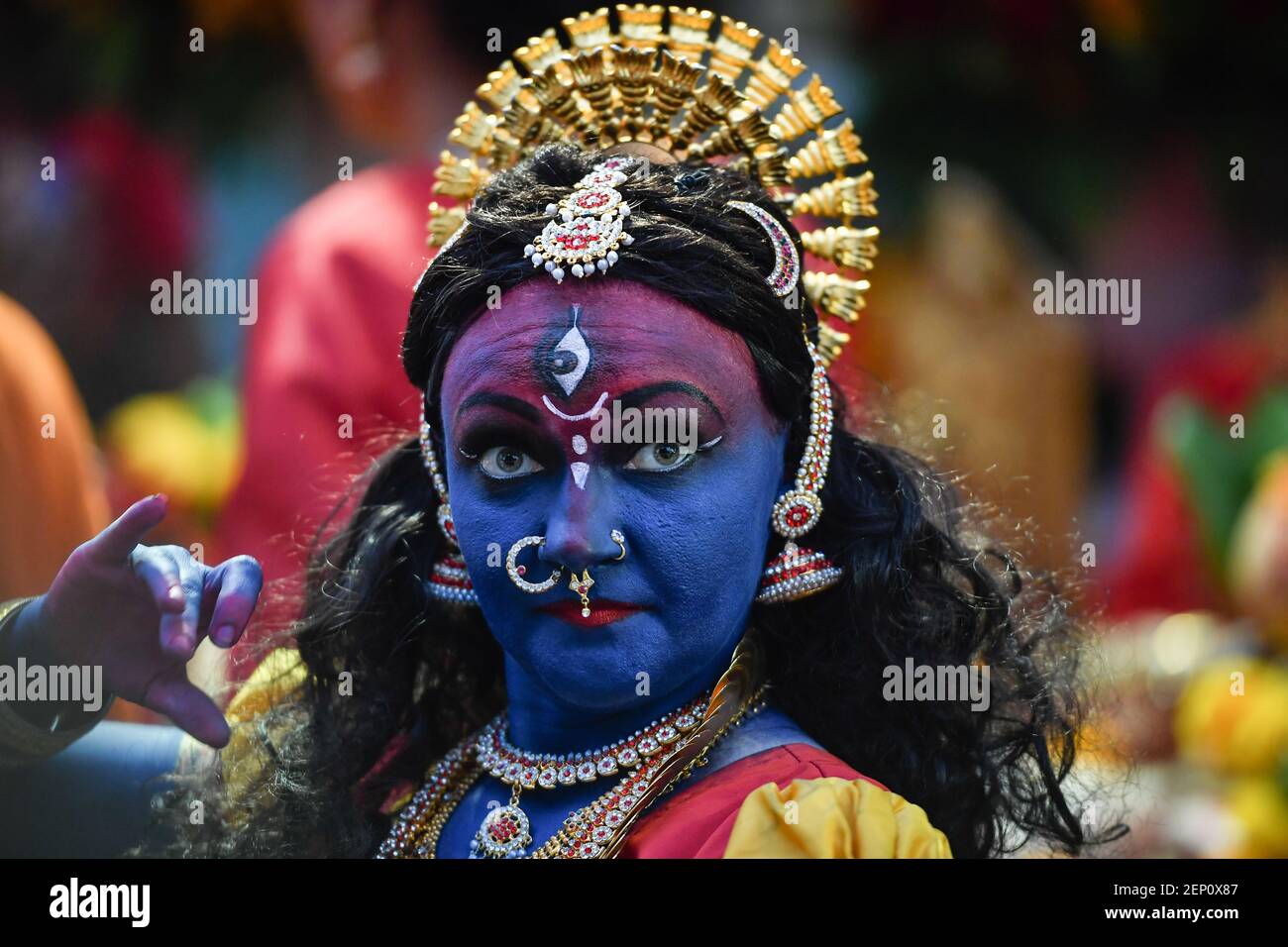A devotee dressed as the Hindu deity Maha Kali performs during Navratri ...