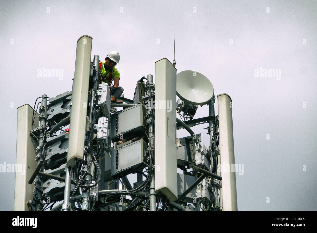 A worker is checking a supporting power machine while conducting ...