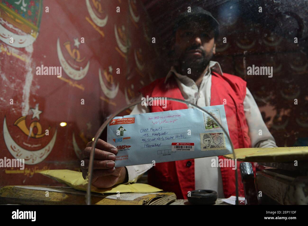 Pakistani post office worker sorts mails after it was unloaded from ...